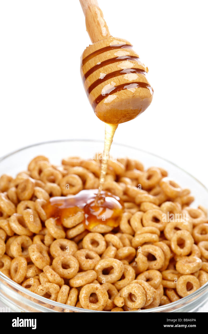 Pouring honey on glass bowl of cornflakes Shallow depth of field Stock ...