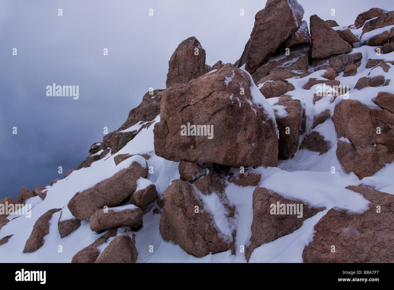 Snow covered rocks on mountain Stock Photo - Alamy