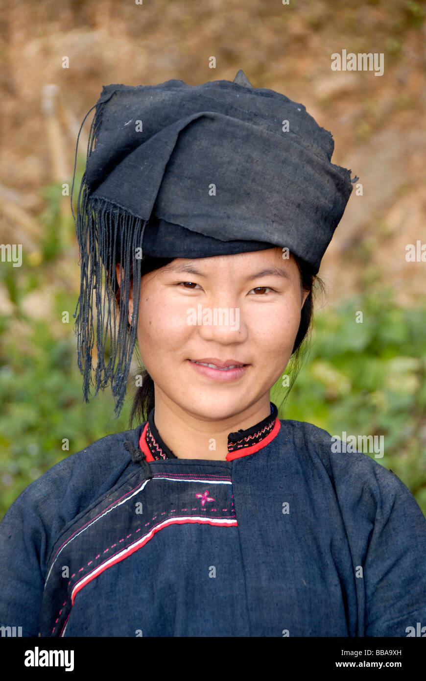 Portrait of a young woman of the Lolo-Hor ethnicity smiling, in ...