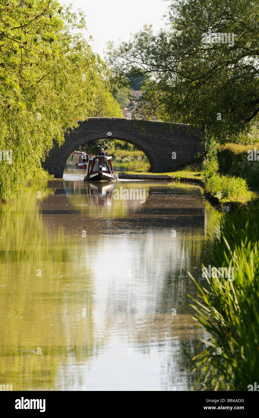 Canal narrowboat coming through a bridge on the Ashby Canal Stock Photo ...
