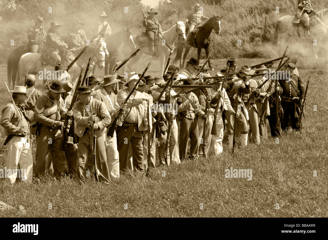 Confederate soldiers preparing muskets and firing during a civil war re ...