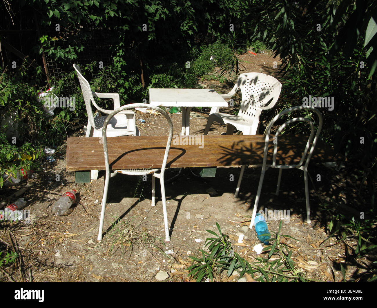 old chairs and table setting on derelict ground field Stock Photo - Alamy