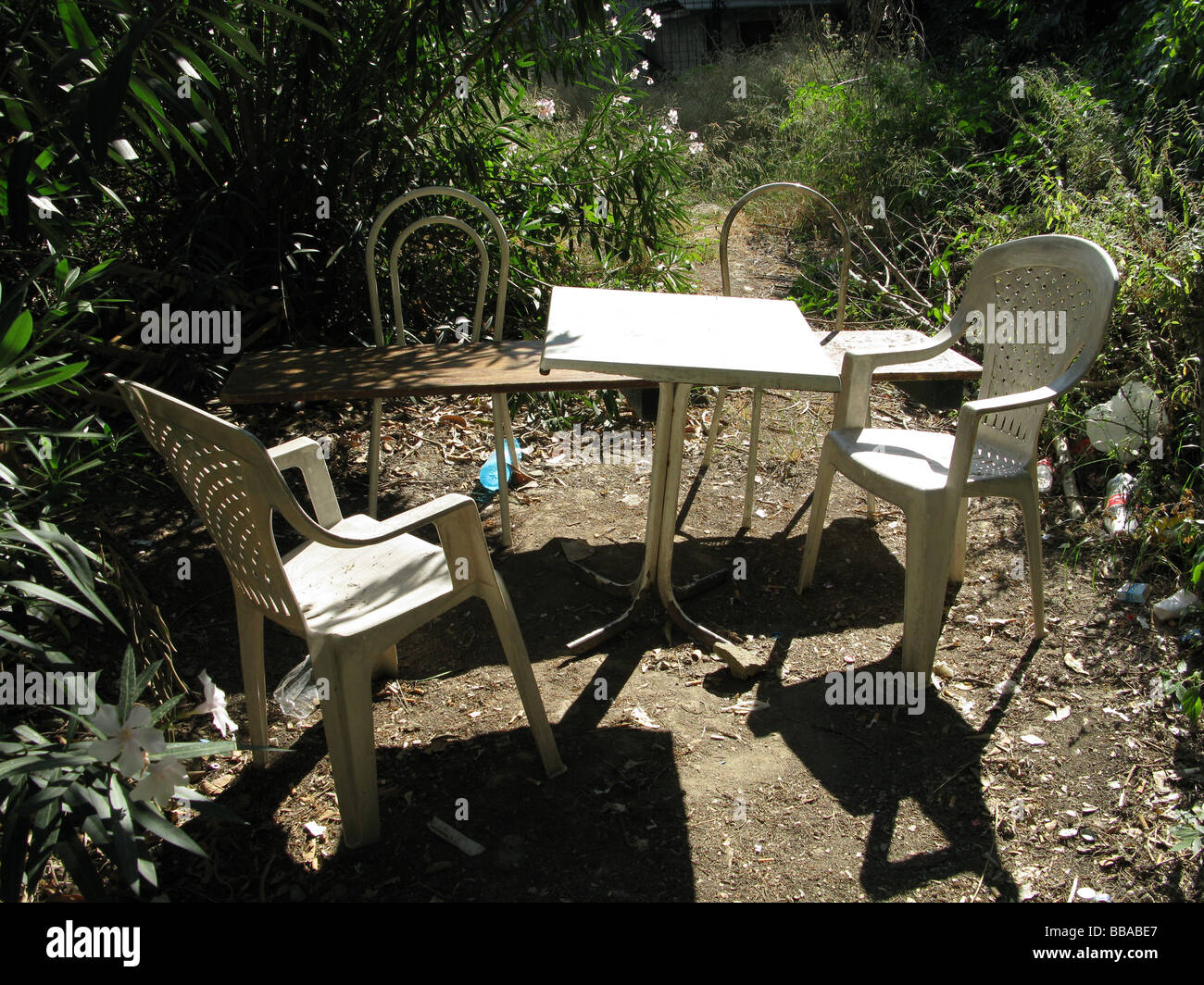 old chairs and table setting on derelict ground field Stock Photo - Alamy