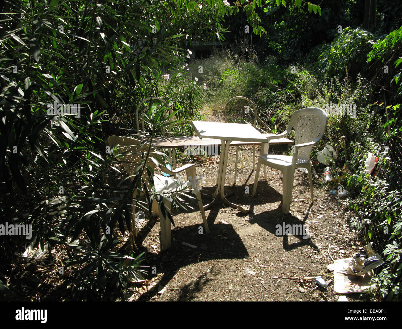 old chairs and table setting on derelict ground field Stock Photo - Alamy