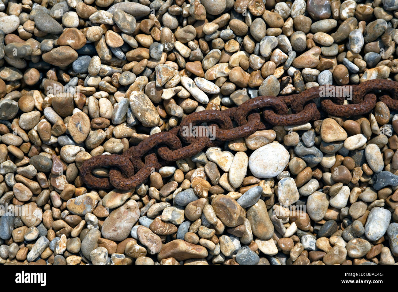 iron chain on a pebble beach on dungeness beach in kent Stock Photo - Alamy