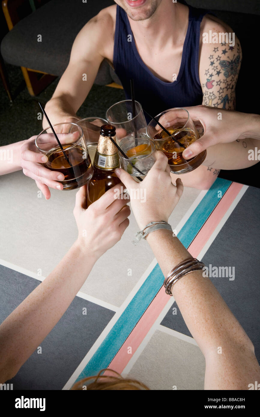 A group of friends toasting drinks at a bar Stock Photo - Alamy
