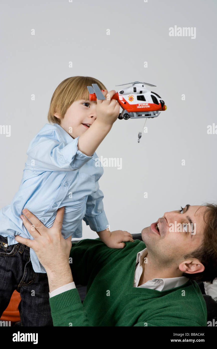 A father and son playing with a toy helicopter Stock Photo - Alamy