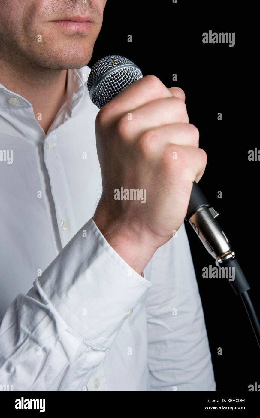 A man holding a microphone Stock Photo - Alamy