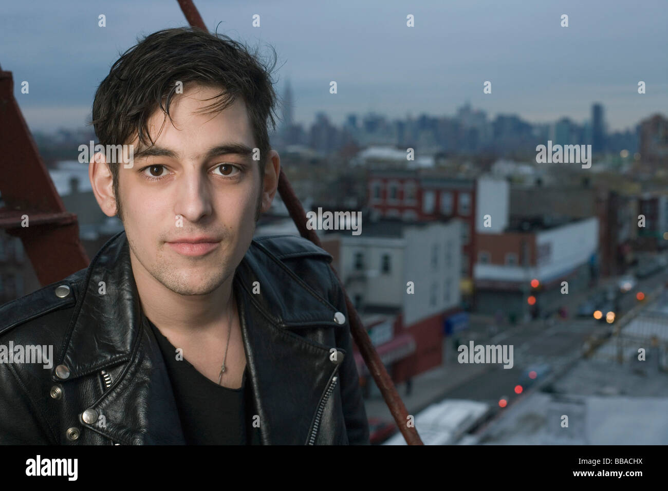 Portrait of a young man on a fire escape Stock Photo - Alamy