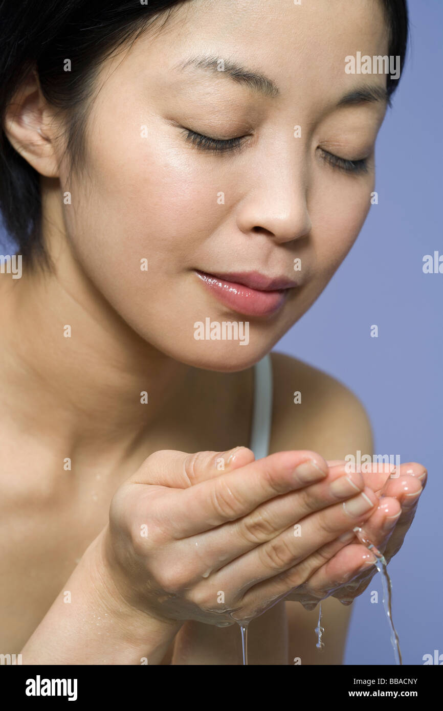 A woman washing her face Stock Photo - Alamy