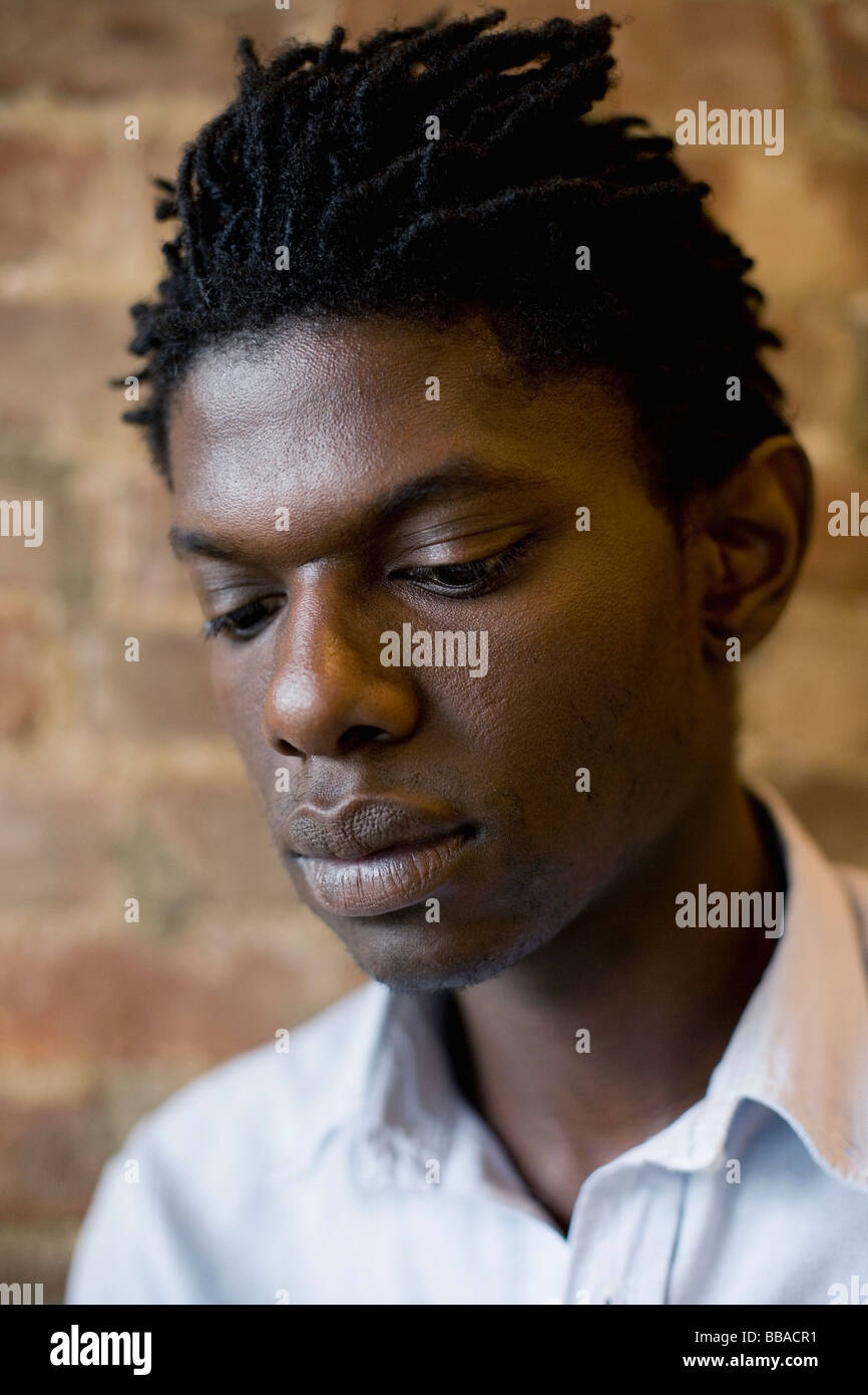 Portrait of a young man looking down Stock Photo - Alamy