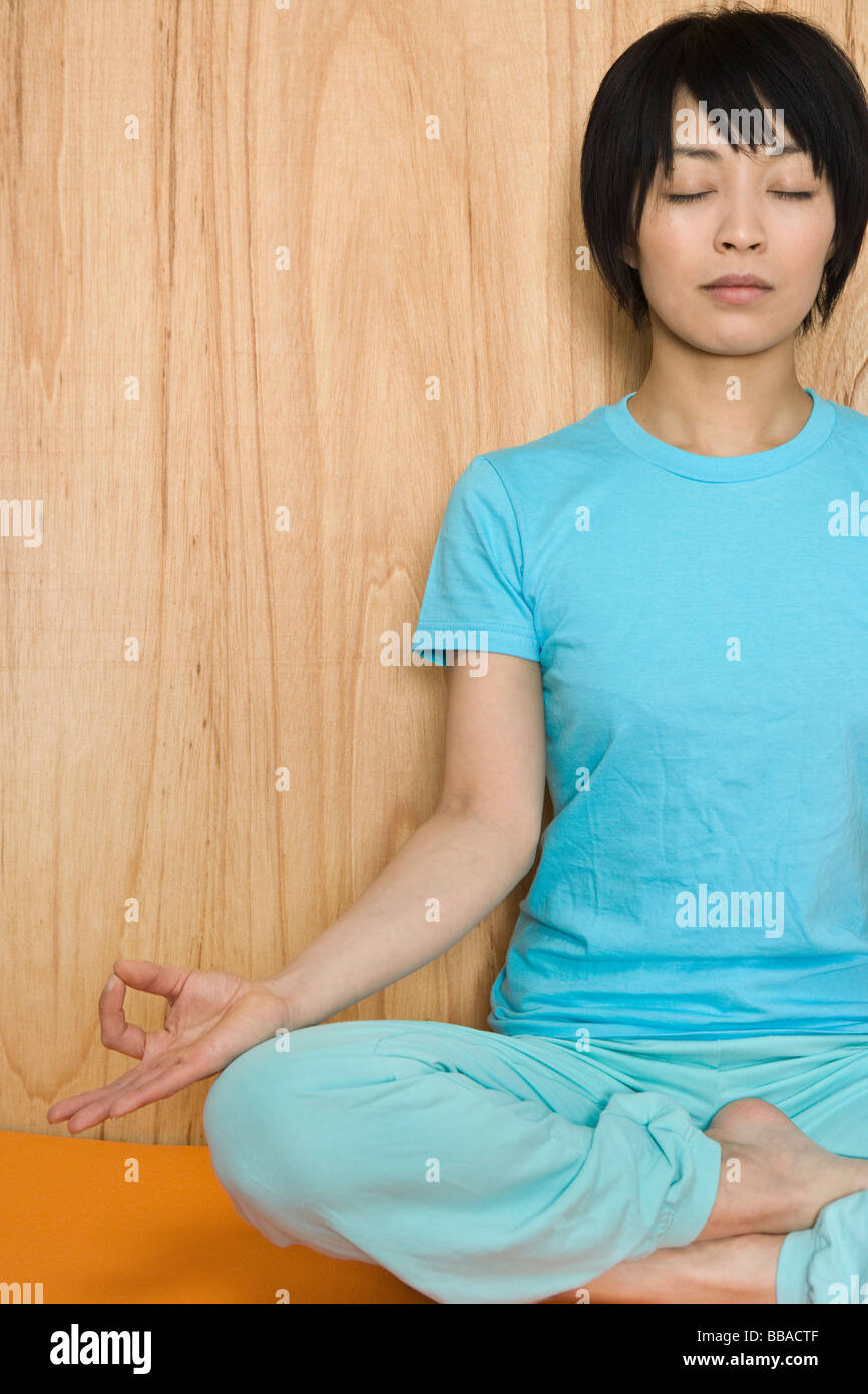 A woman sitting in the lotus position Stock Photo - Alamy