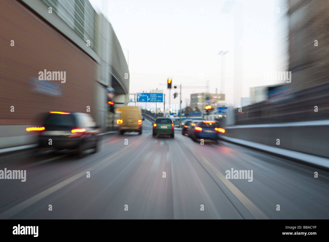 Rear view of vehicles driving along a road at speed Stock Photo - Alamy