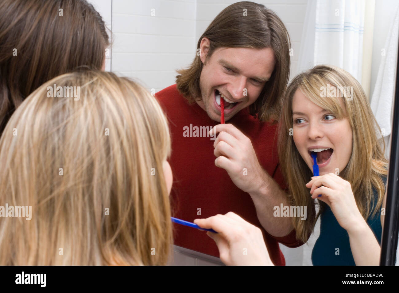 A young couple brushing their teeth together Stock Photo - Alamy