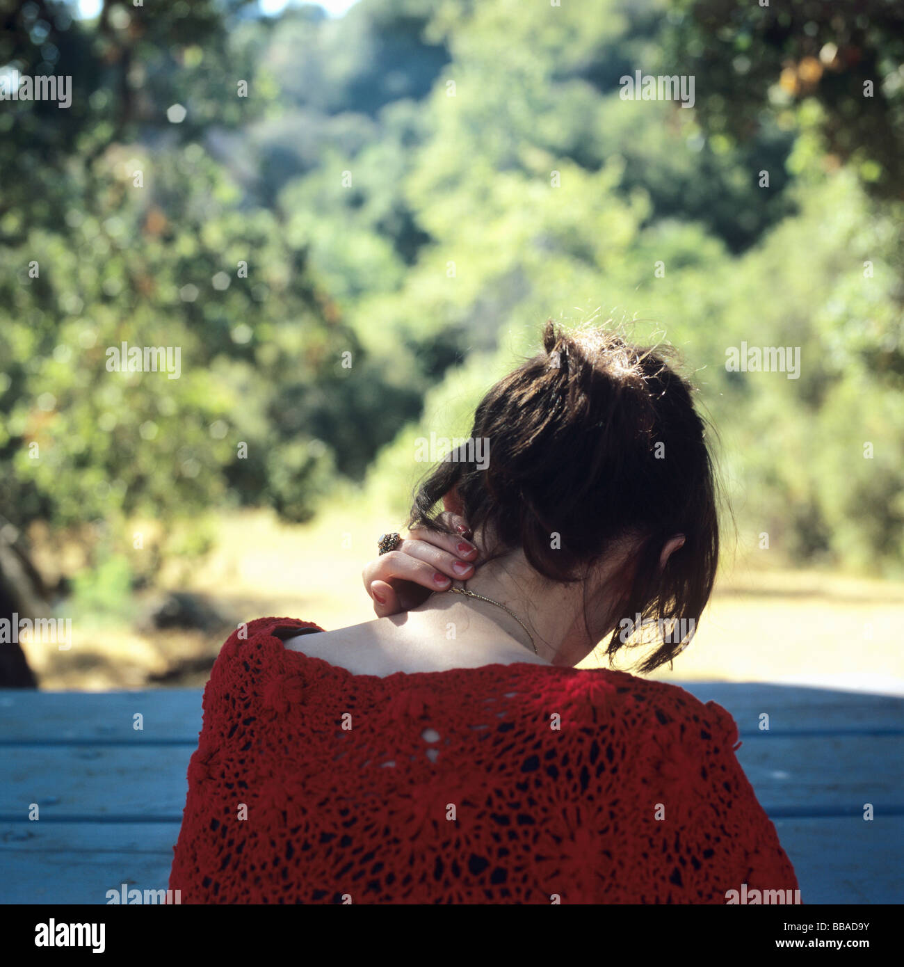 Woman touching back neck rear hi-res stock photography and images - Alamy