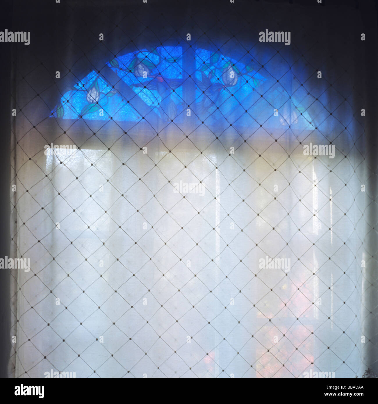 A sheet hanging over a stained glass window Stock Photo - Alamy