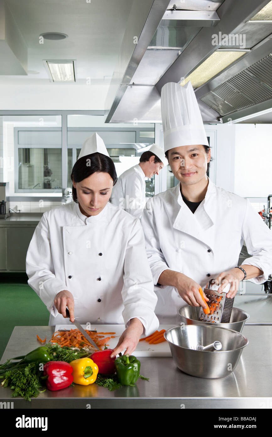 Two chefs doing prep work in a commercial kitchen Stock Photo - Alamy