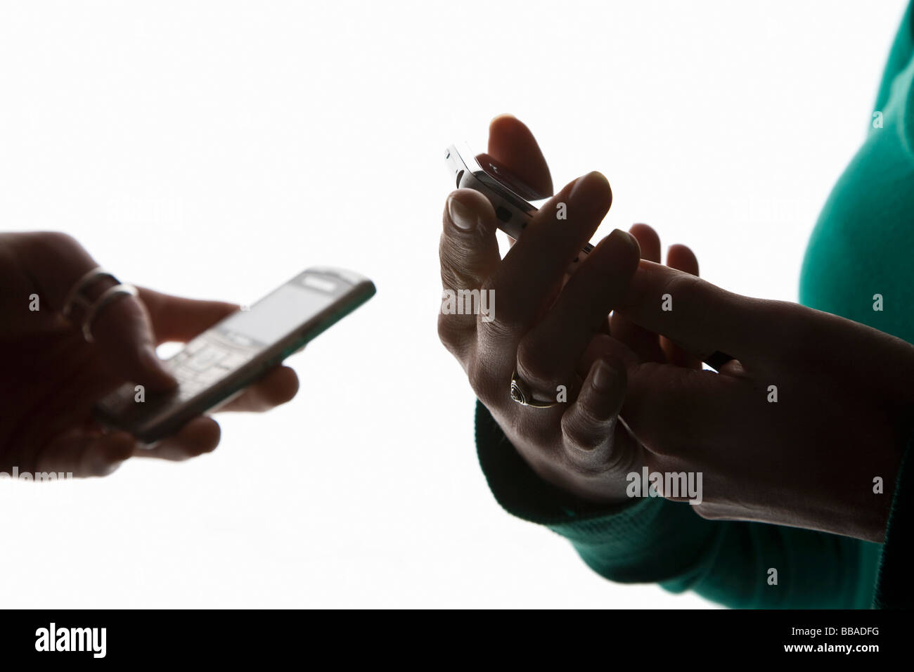 The hands of two people using mobile phones Stock Photo - Alamy