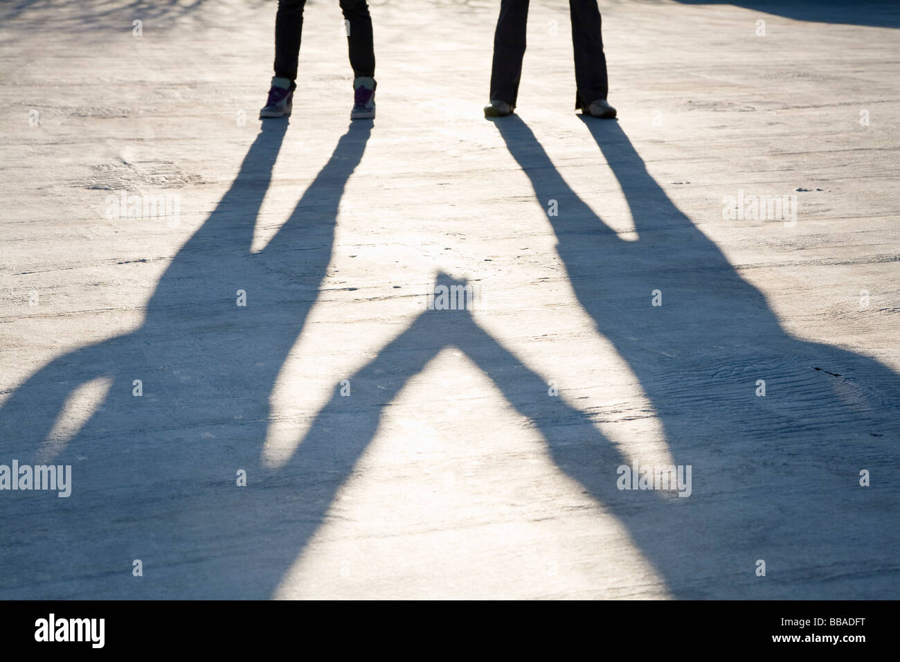 The legs of two people holding hands Stock Photo - Alamy