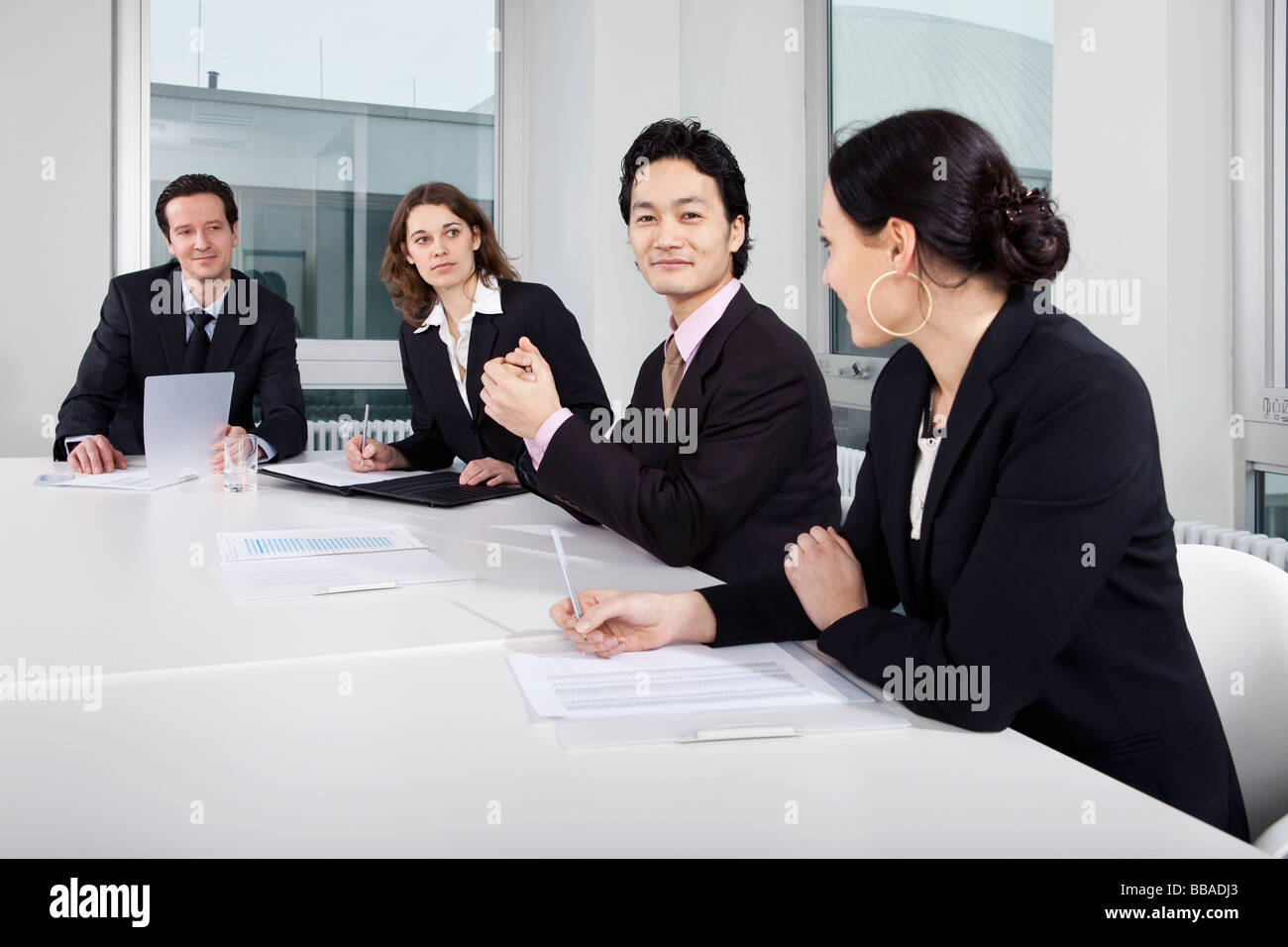 Four business people in a business meeting Stock Photo - Alamy
