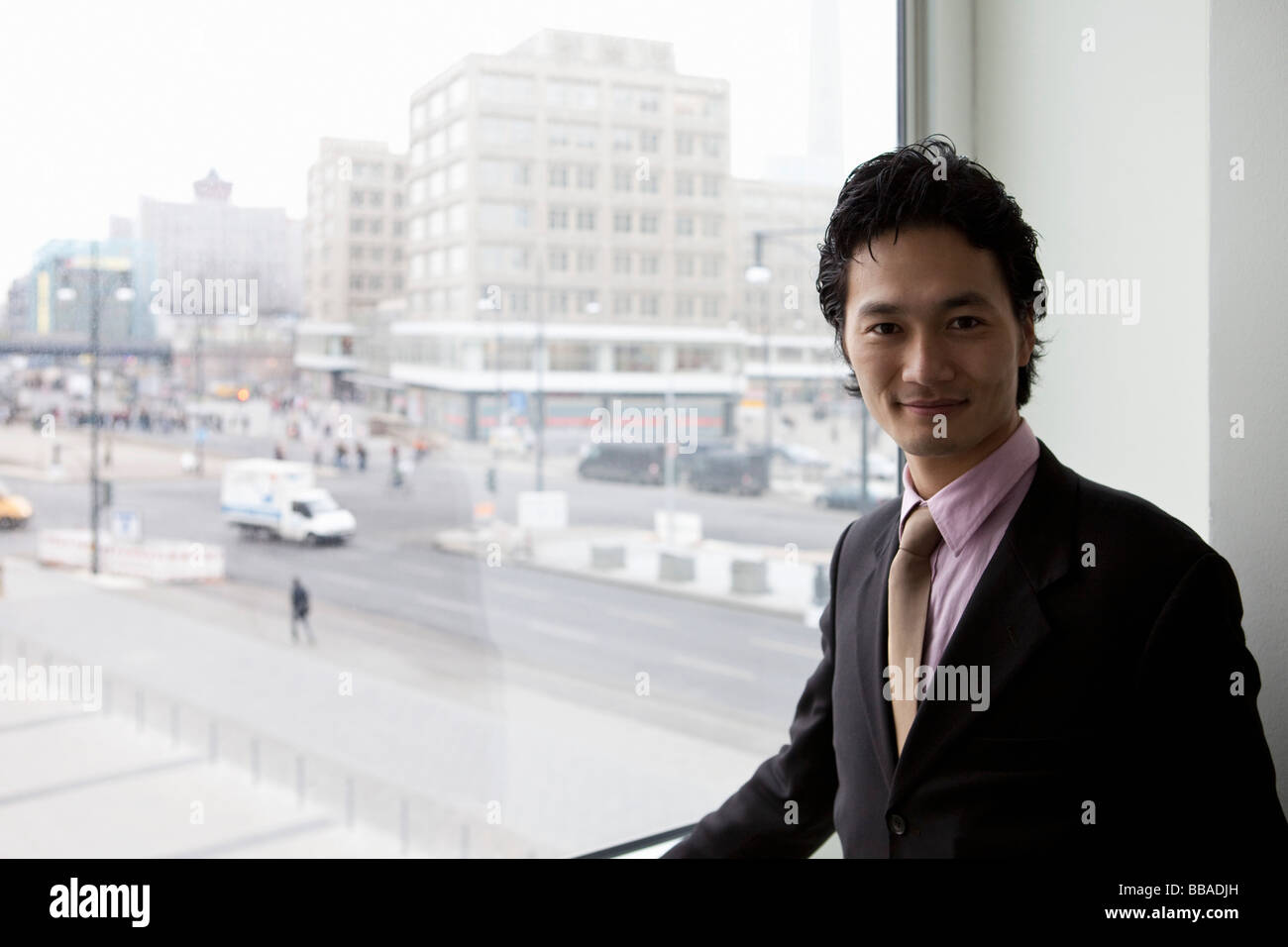 Portrait of a businessman standing next to a window Stock Photo - Alamy