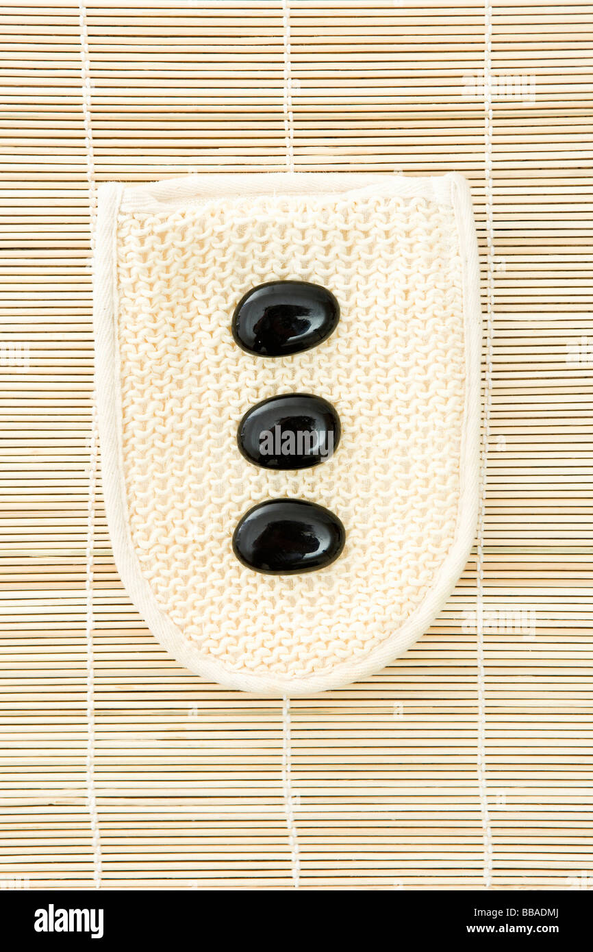 Lastone therapy stones on a loofah Stock Photo - Alamy