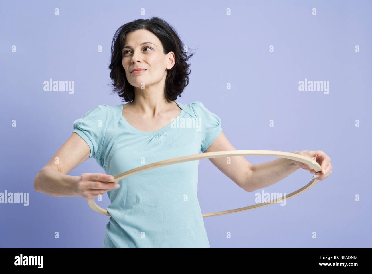 A woman using a hula hoop Stock Photo - Alamy