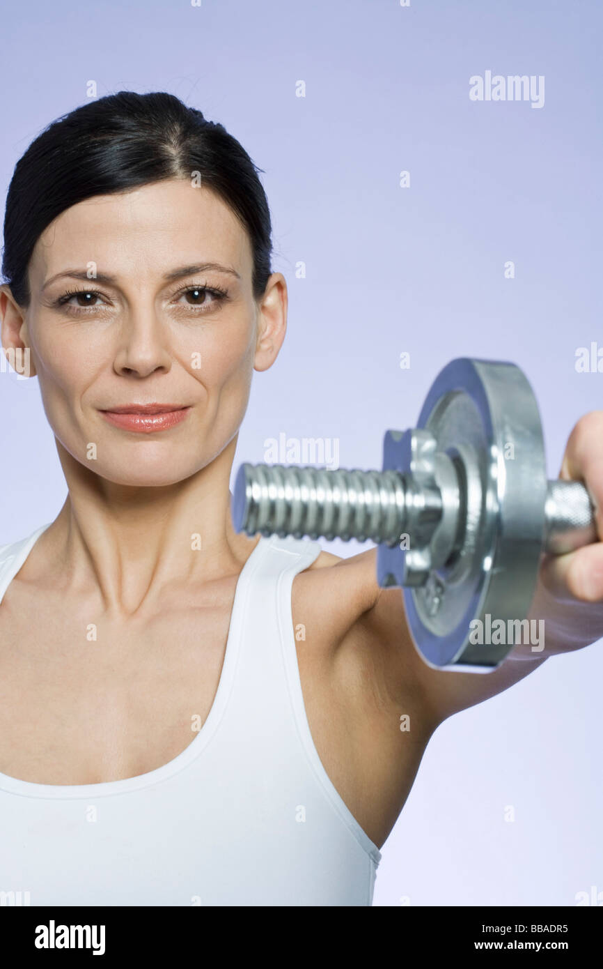 A woman lifting a dumbbell Stock Photo - Alamy