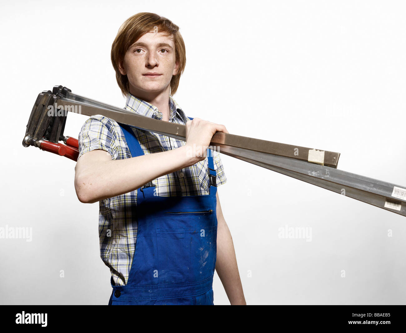 A young man holding calipers Stock Photo - Alamy