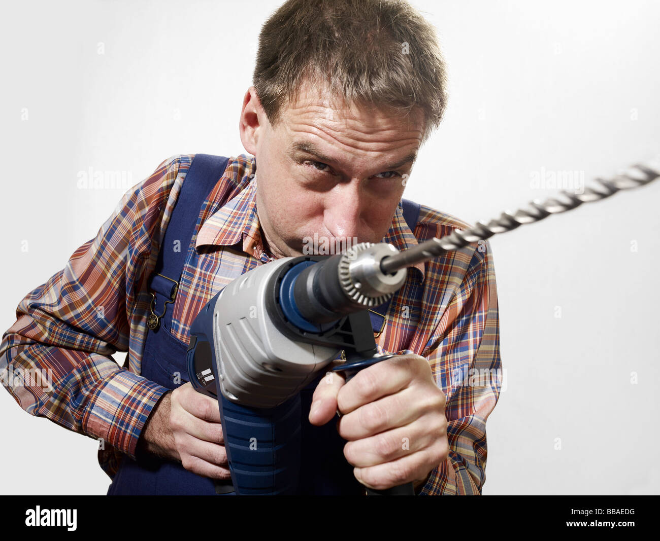Man holding large drill hi-res stock photography and images - Alamy