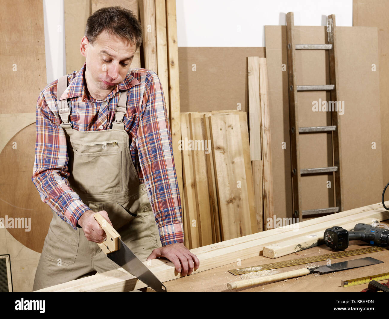 Man sawing wood hi-res stock photography and images - Alamy