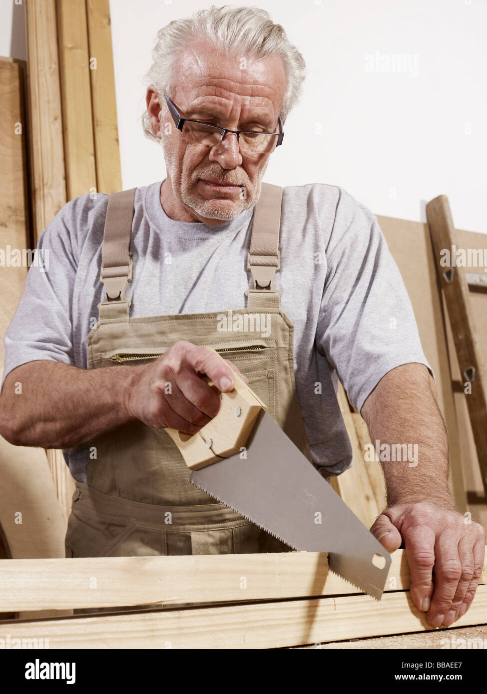 A man sawing wood Stock Photo - Alamy