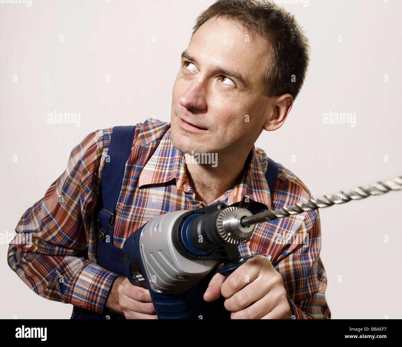 Mature carpenter holding drill hi-res stock photography and images - Alamy