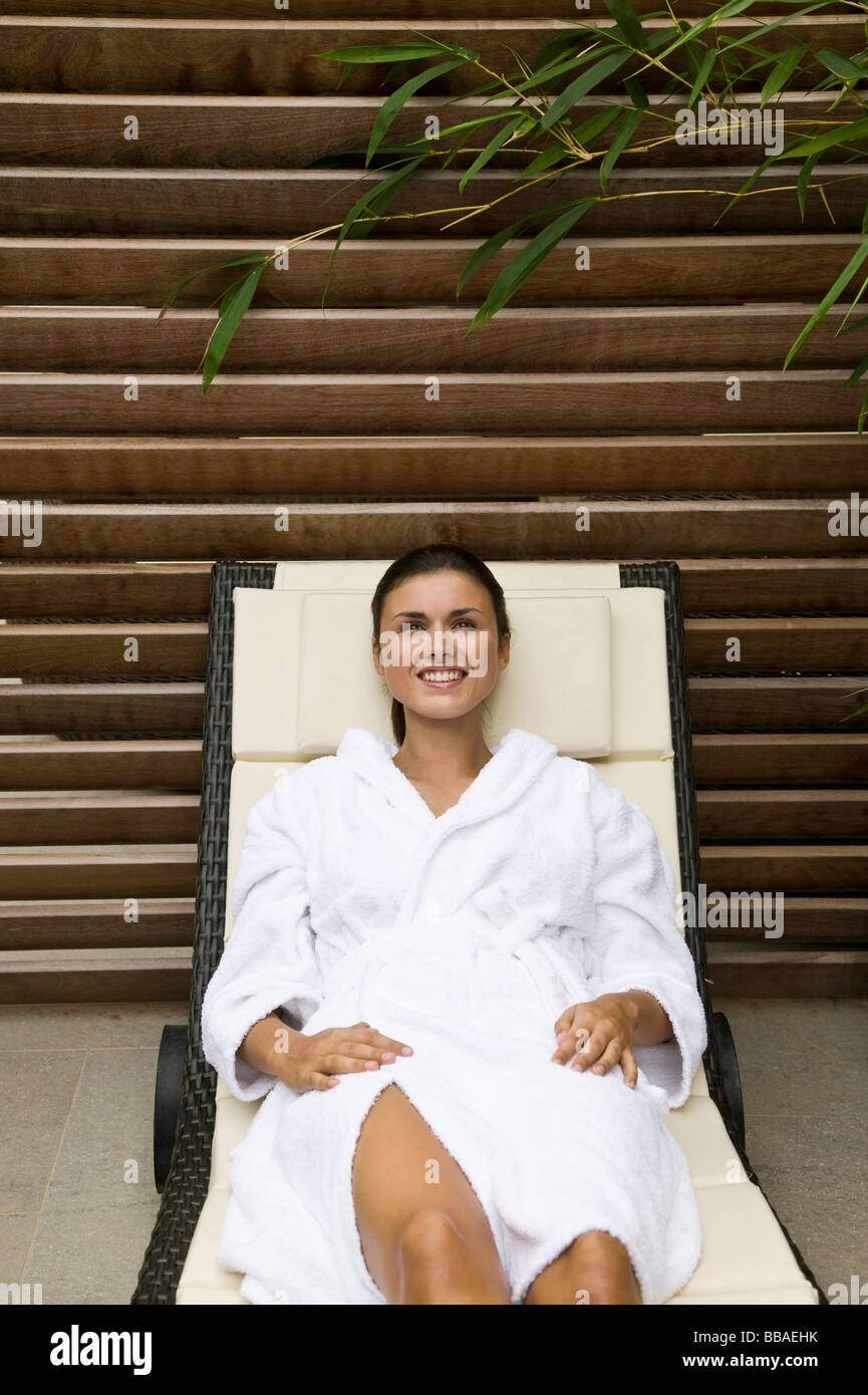 A woman lying in a lounge chair Stock Photo - Alamy