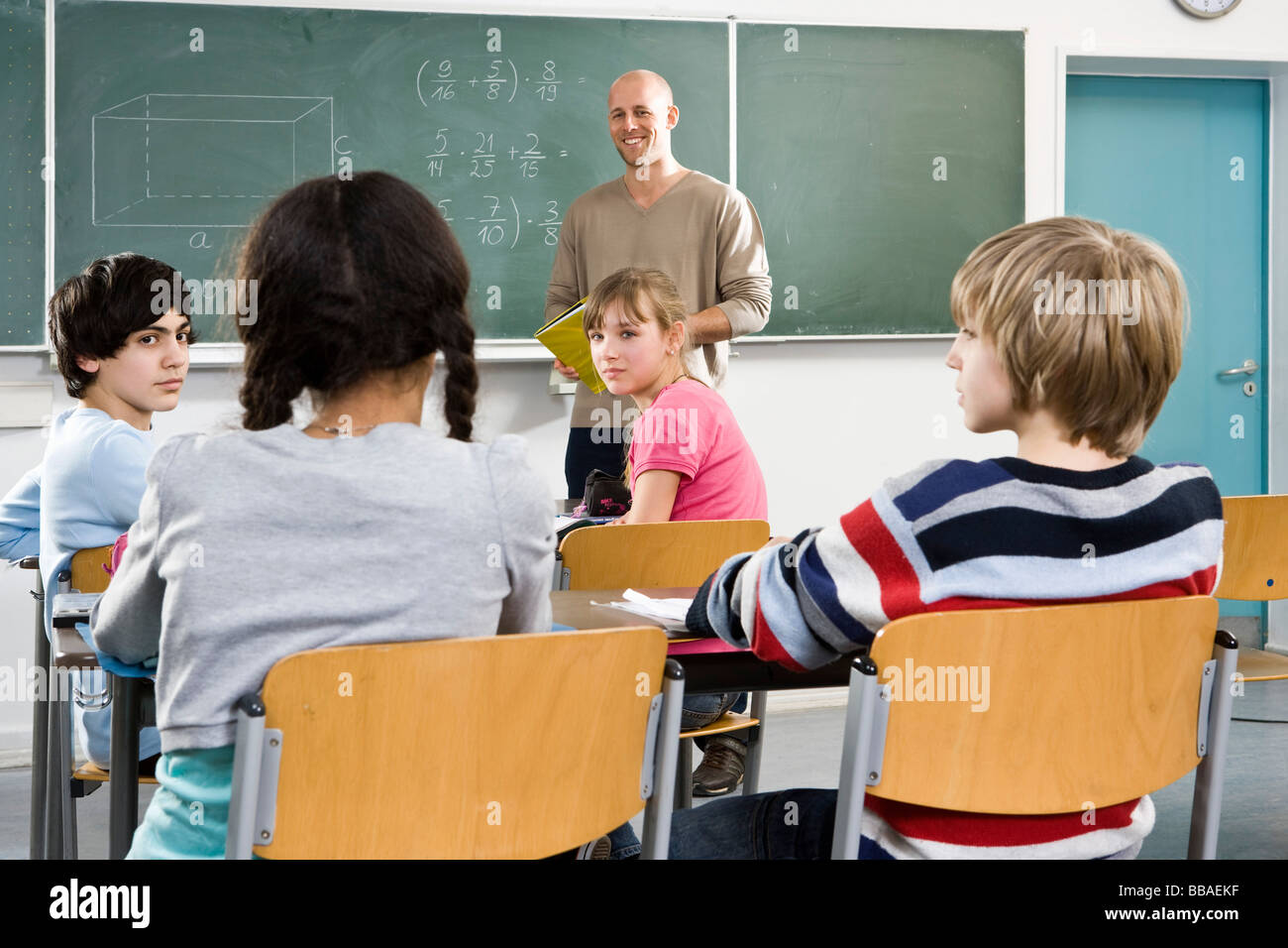 Students and a teacher in a classroom Stock Photo - Alamy