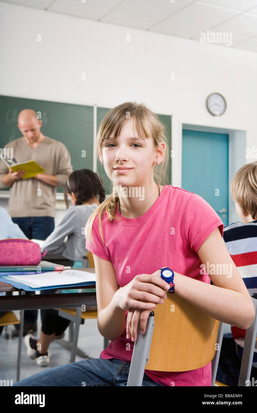 Portrait of a girl sitting in a classroom Stock Photo - Alamy