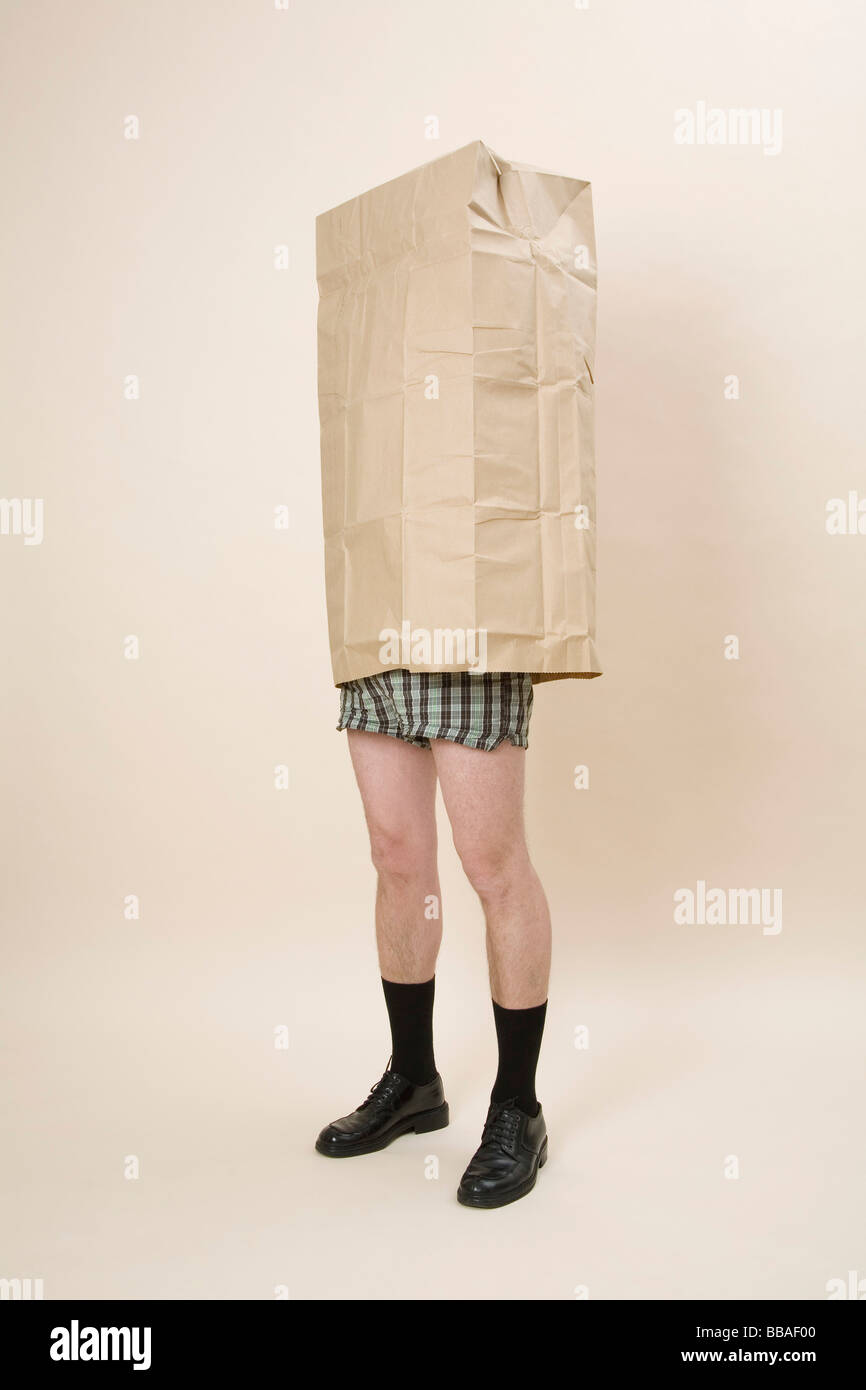 A semi-dressed man wearing a large paper bag Stock Photo - Alamy