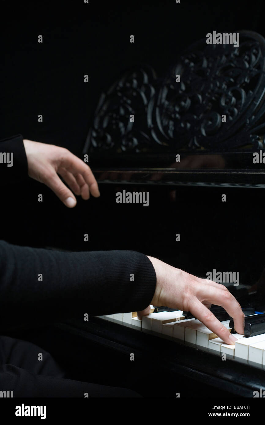 Human hands playing a piano Stock Photo - Alamy
