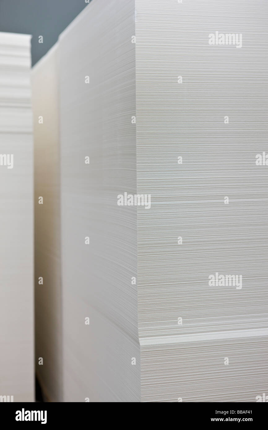 Stacks of white paper at a printers Stock Photo - Alamy