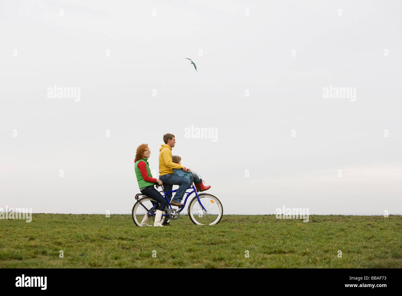 A young family on a bike together Stock Photo - Alamy
