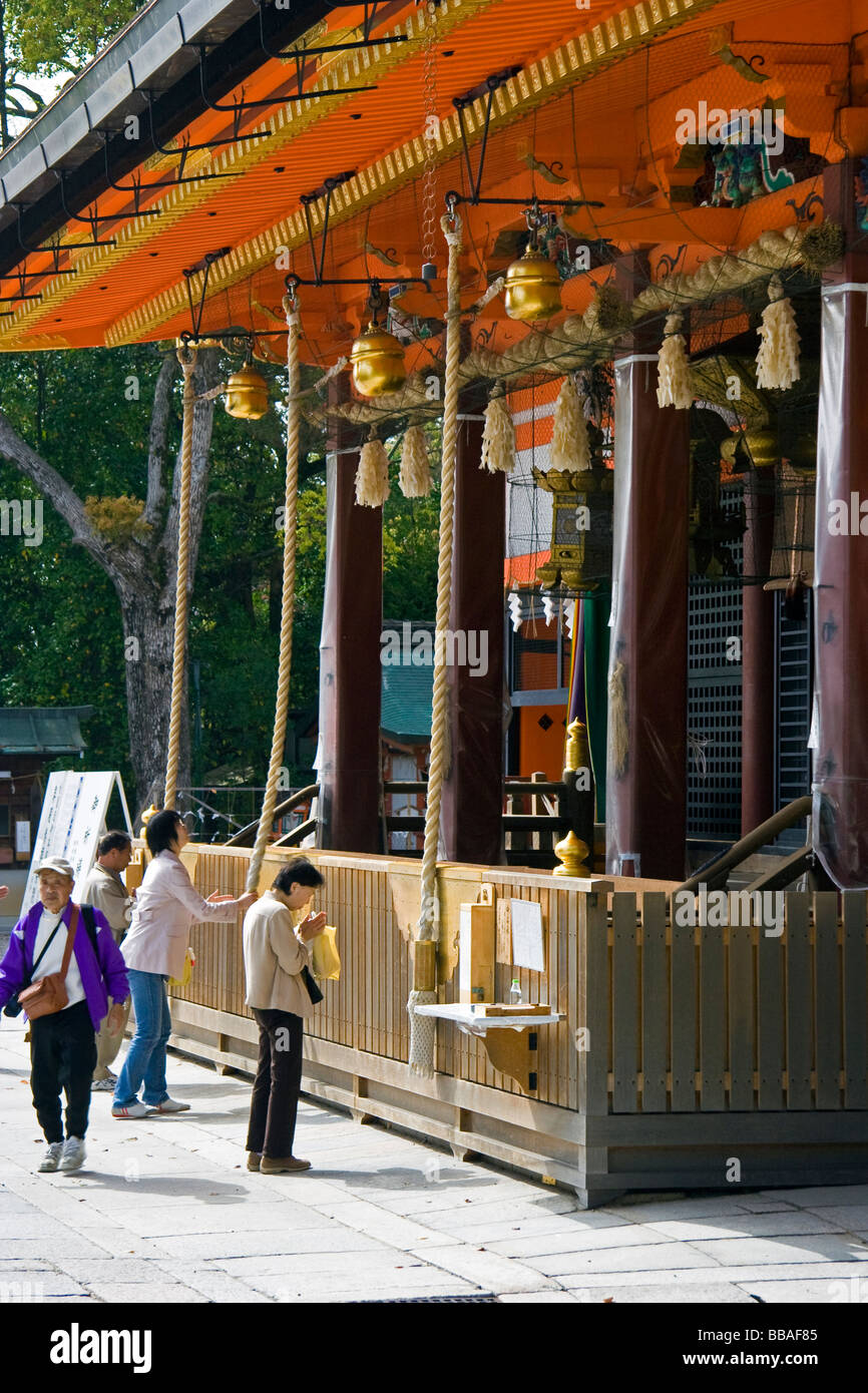 Japanese people standing, bowing and praying in front of the large ...