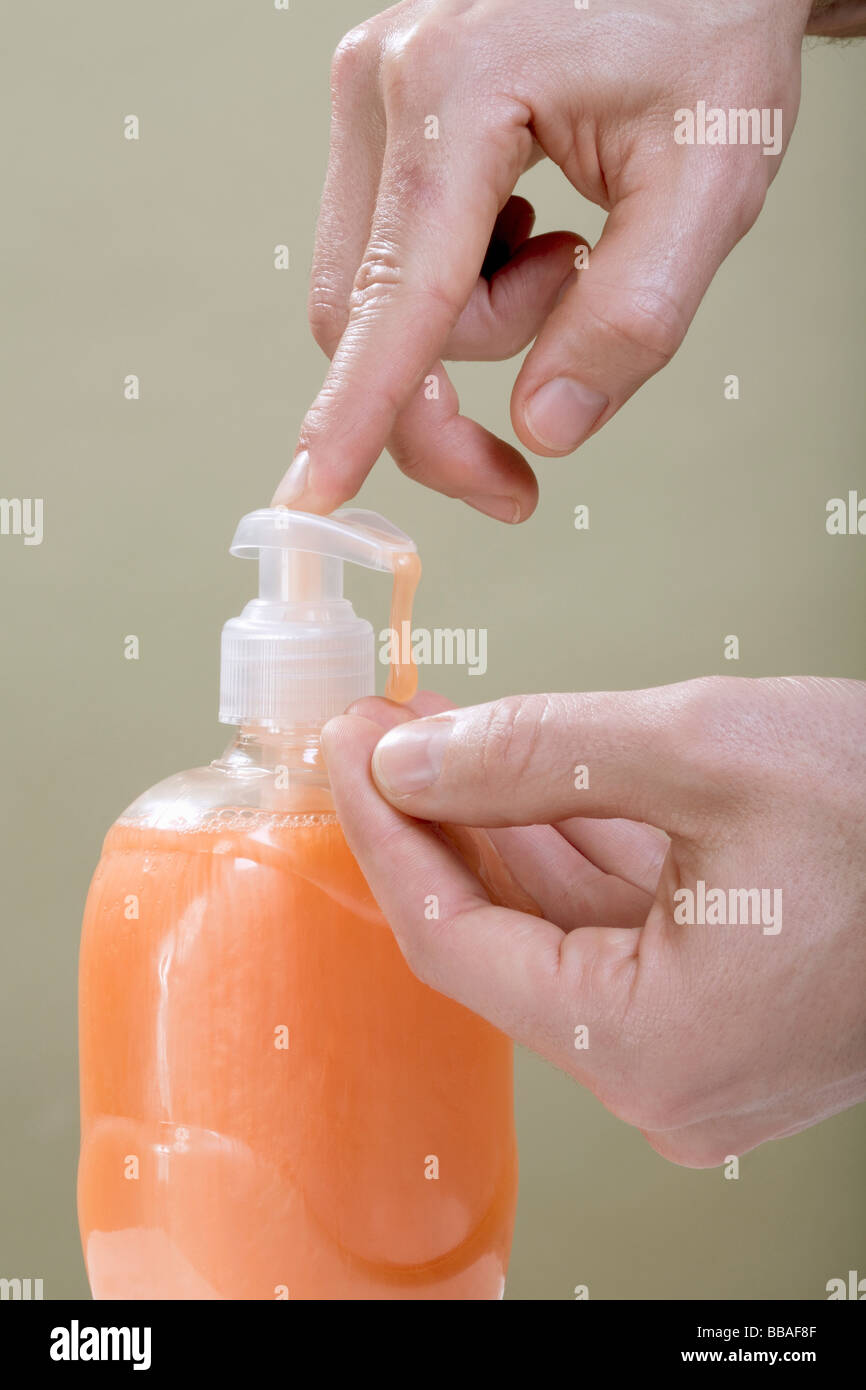 Human hands using liquid soap Stock Photo - Alamy