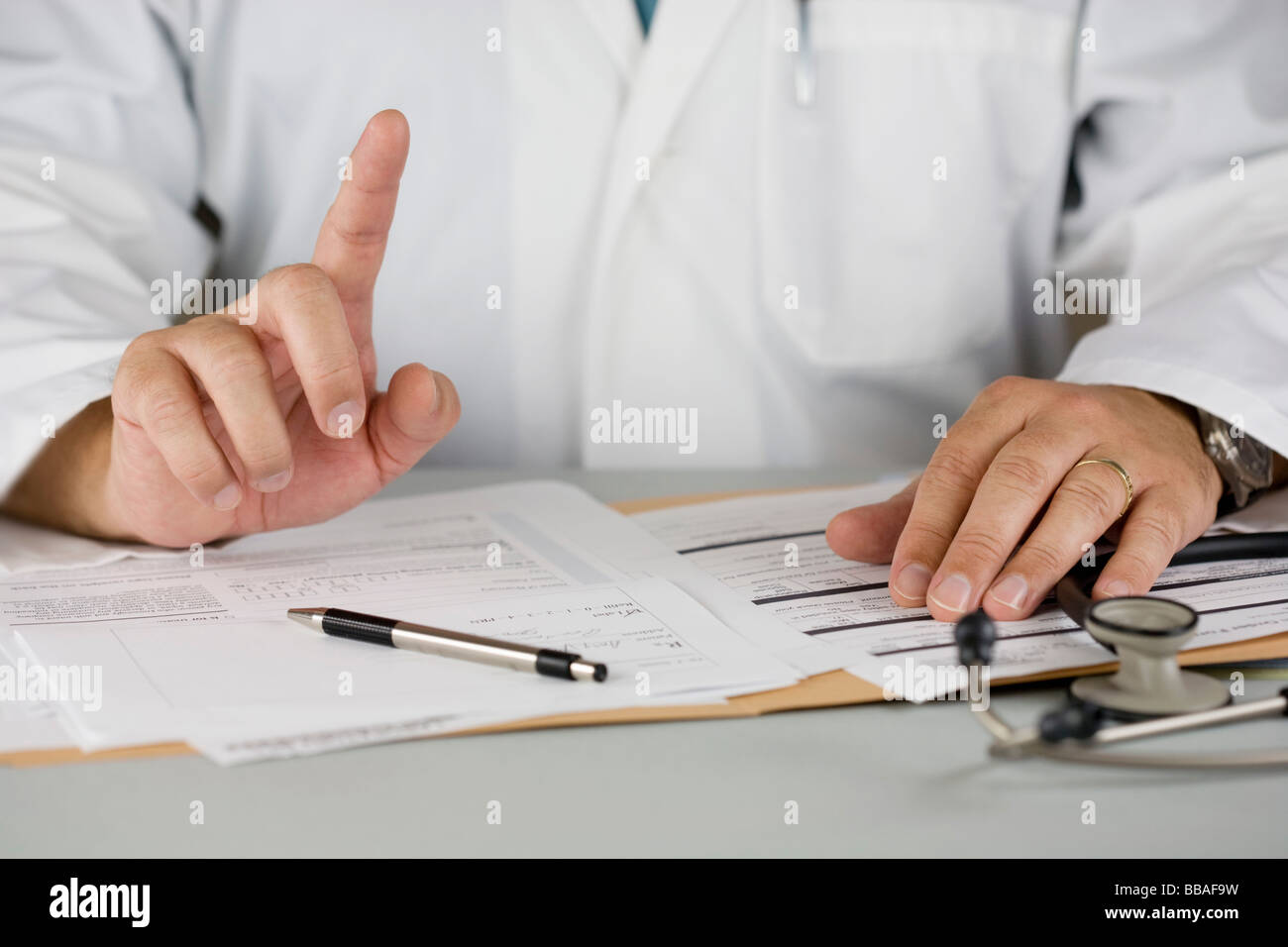 A doctor sitting at a desk Stock Photo - Alamy