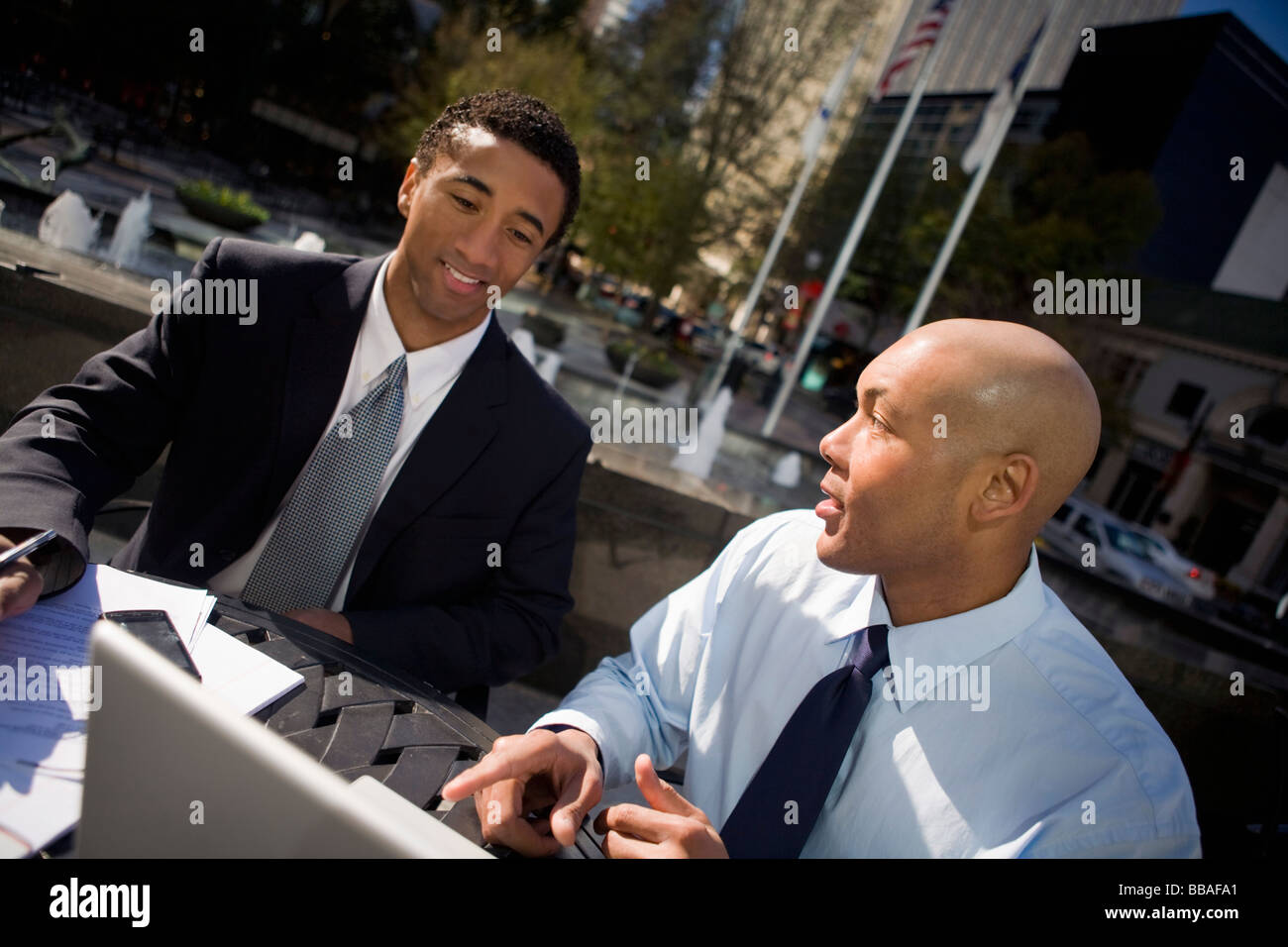 Two businessmen talking outdoors Stock Photo - Alamy