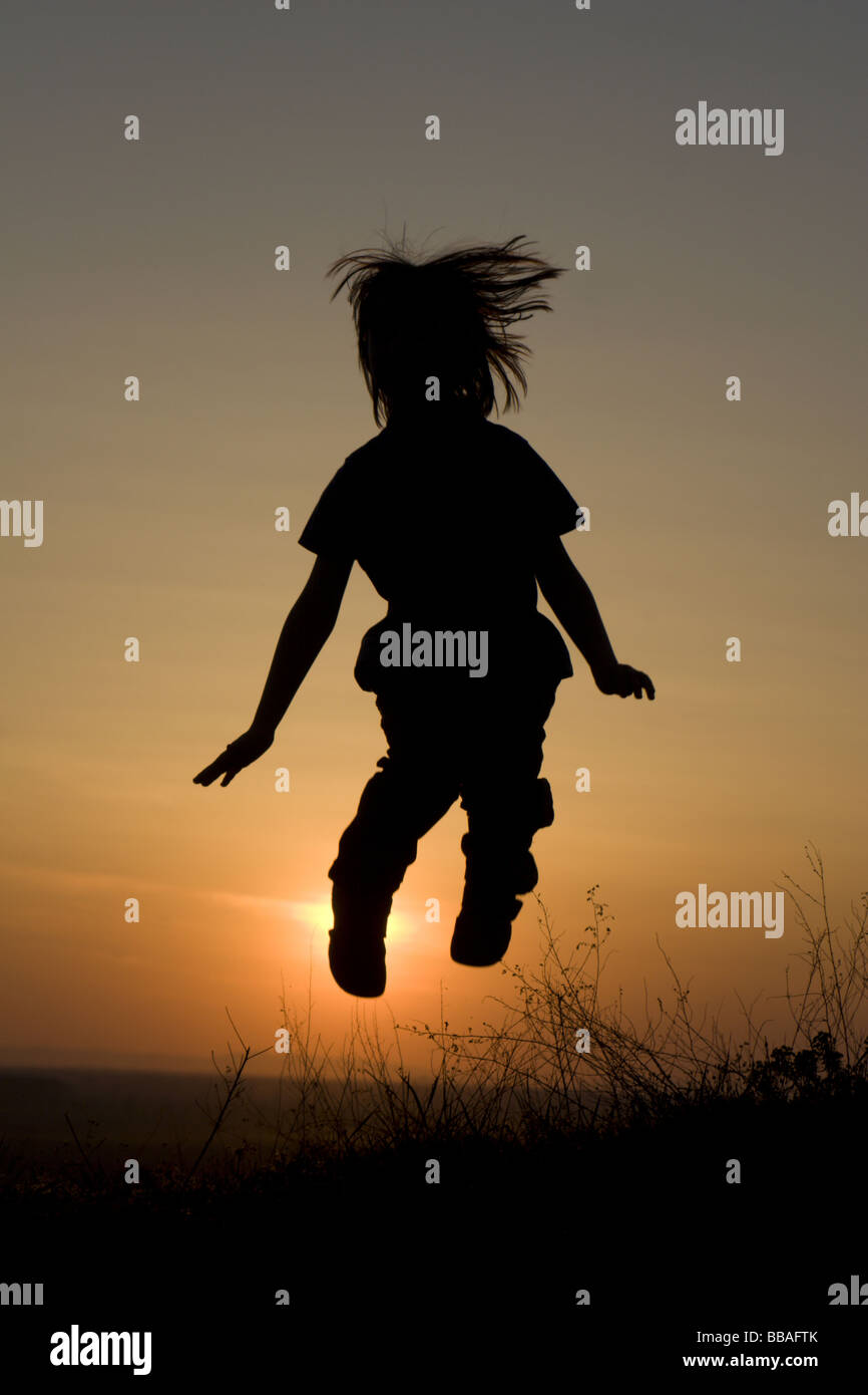 jump of child in sunset - silhouette Stock Photo - Alamy