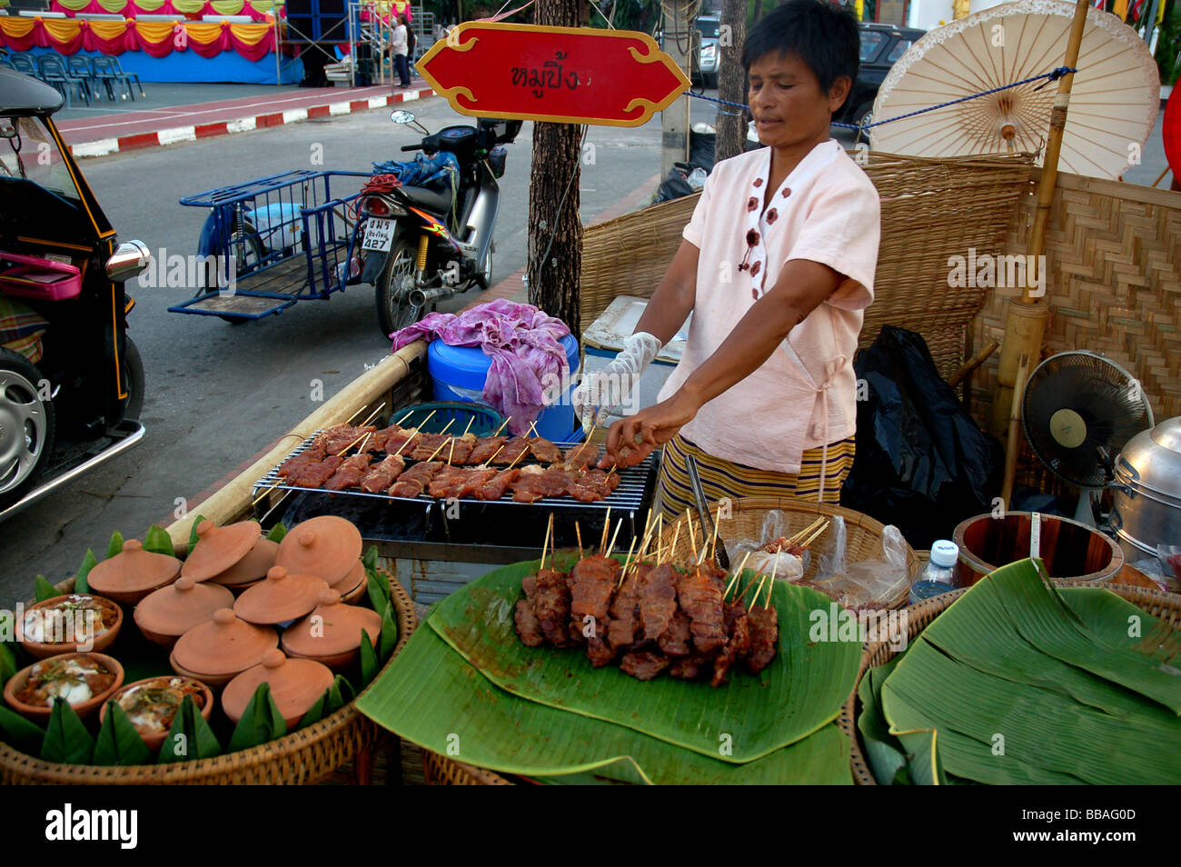 Thai woman selling grilled fish-sticks in Chiang Mai, Thailand Stock ...