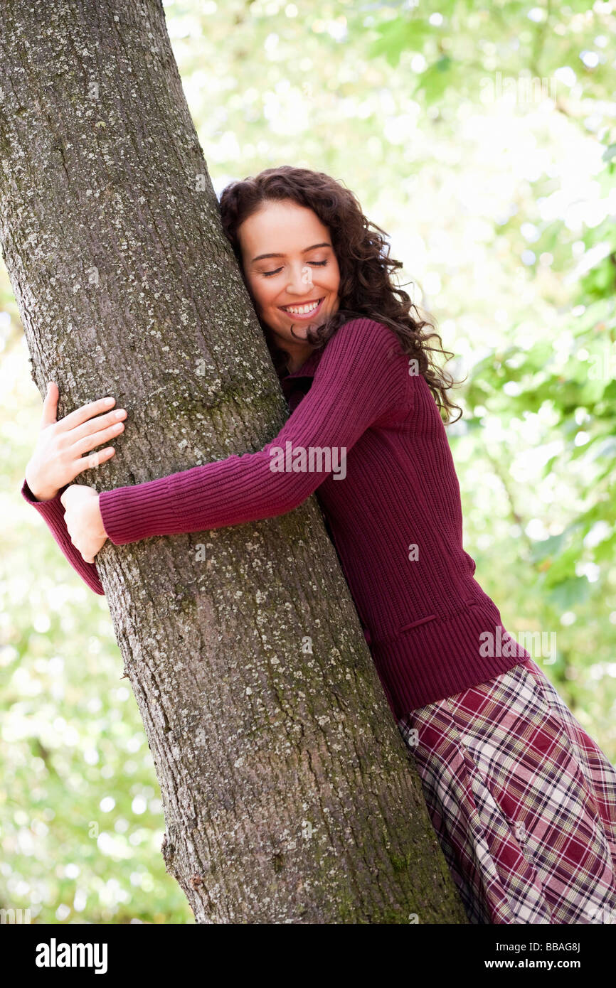 young woman hugging tree Stock Photo - Alamy