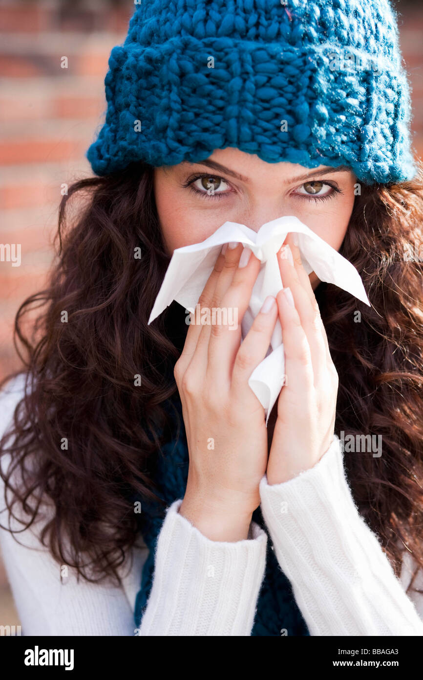young woman wiping nose Stock Photo - Alamy