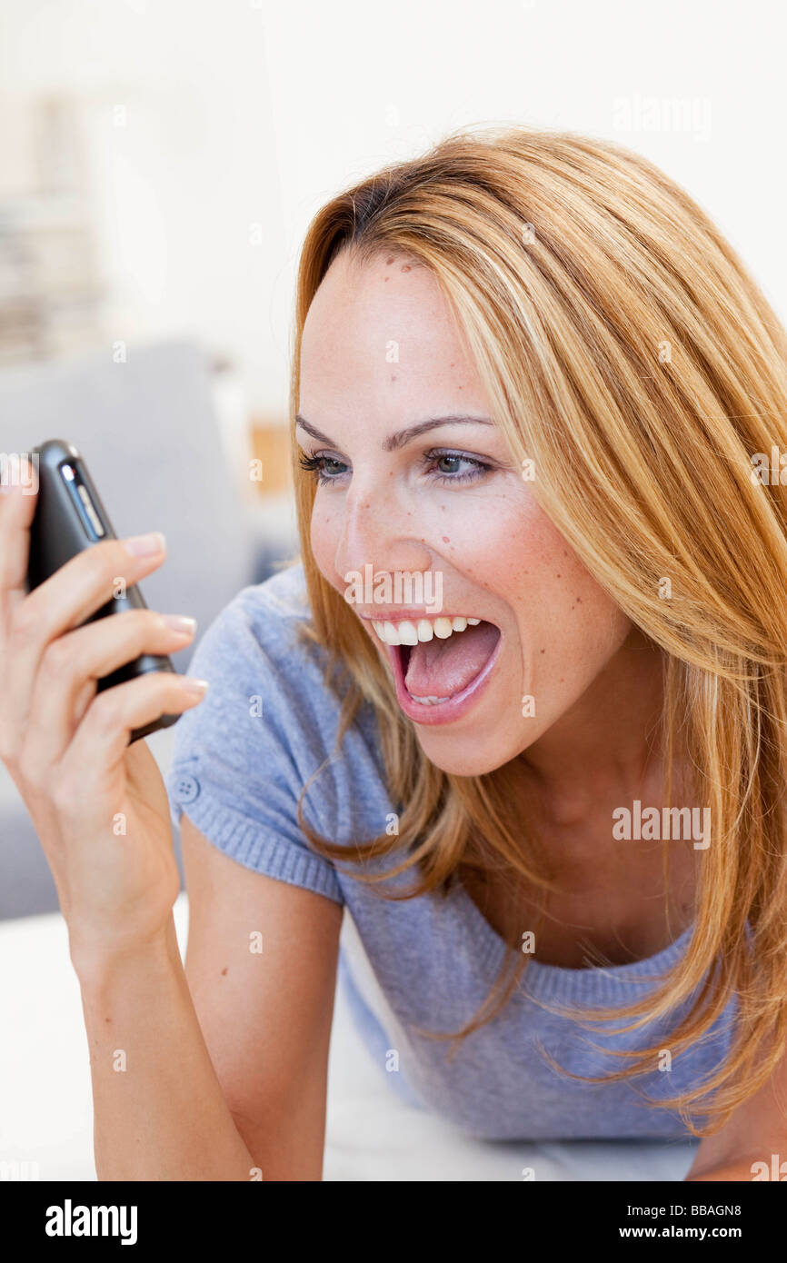young woman screaming into cell phone Stock Photo - Alamy