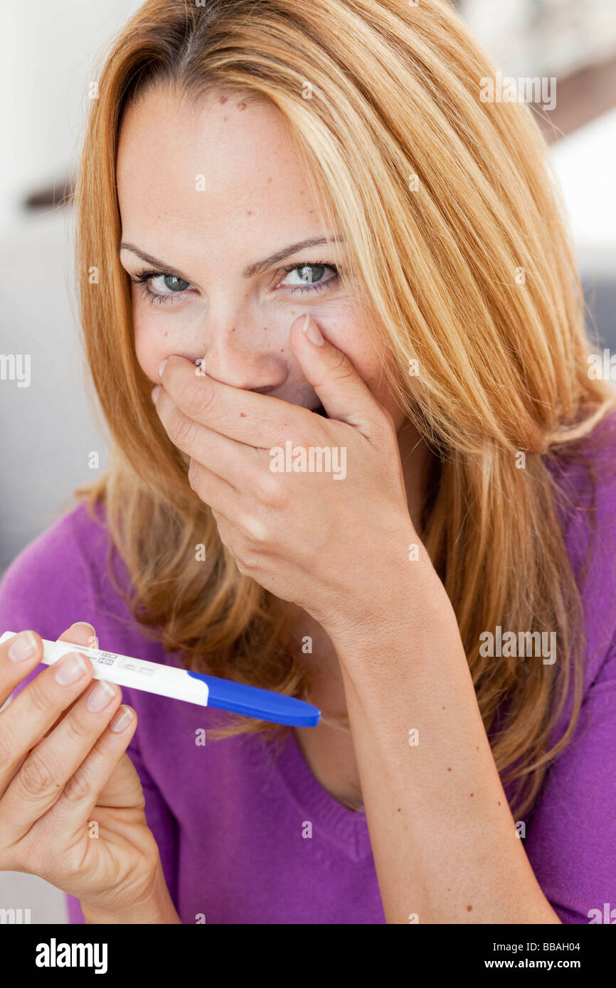 young woman holding pregnancy test Stock Photo - Alamy